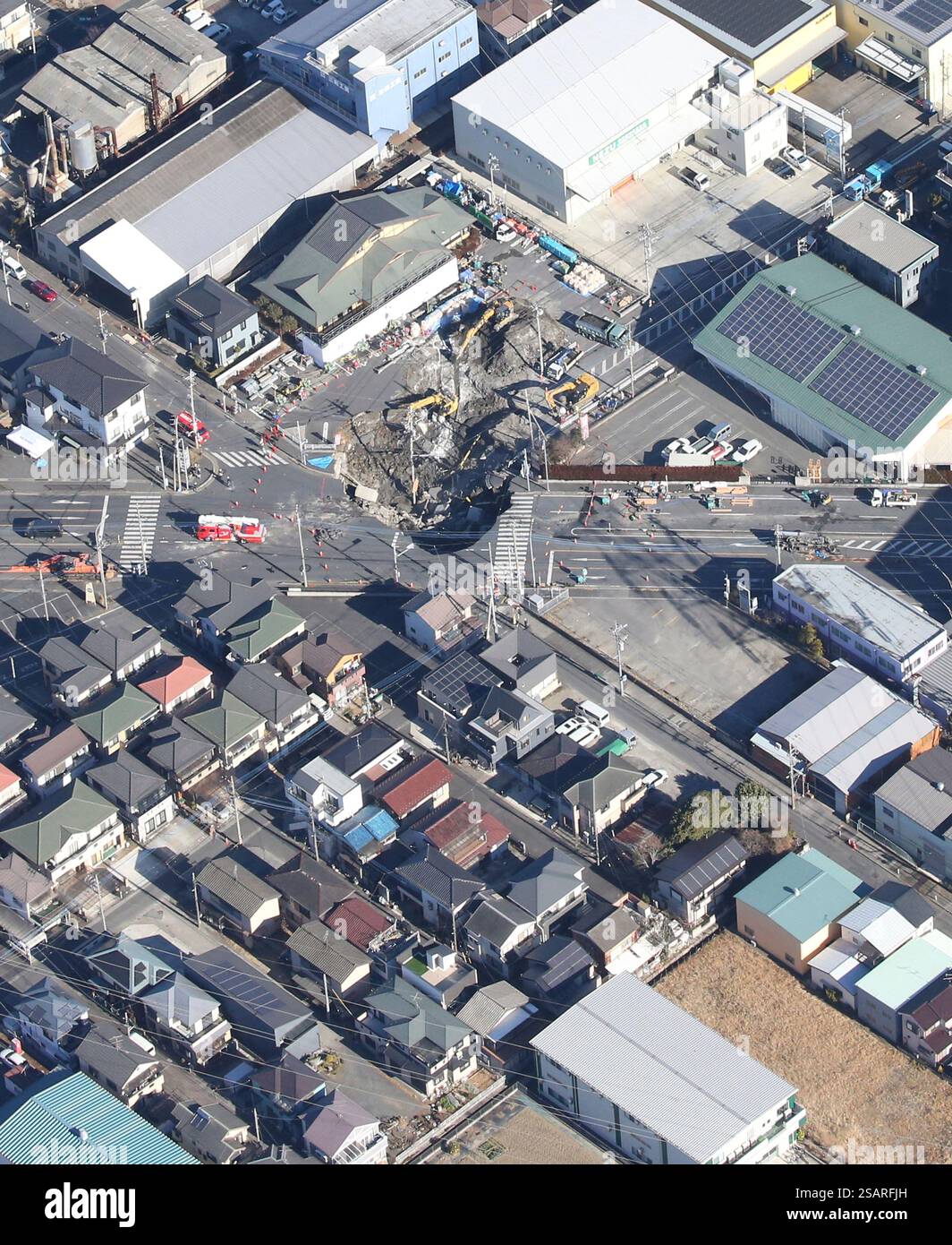 An aerial photo shows sinkholes at an intersection in Yashio City ...