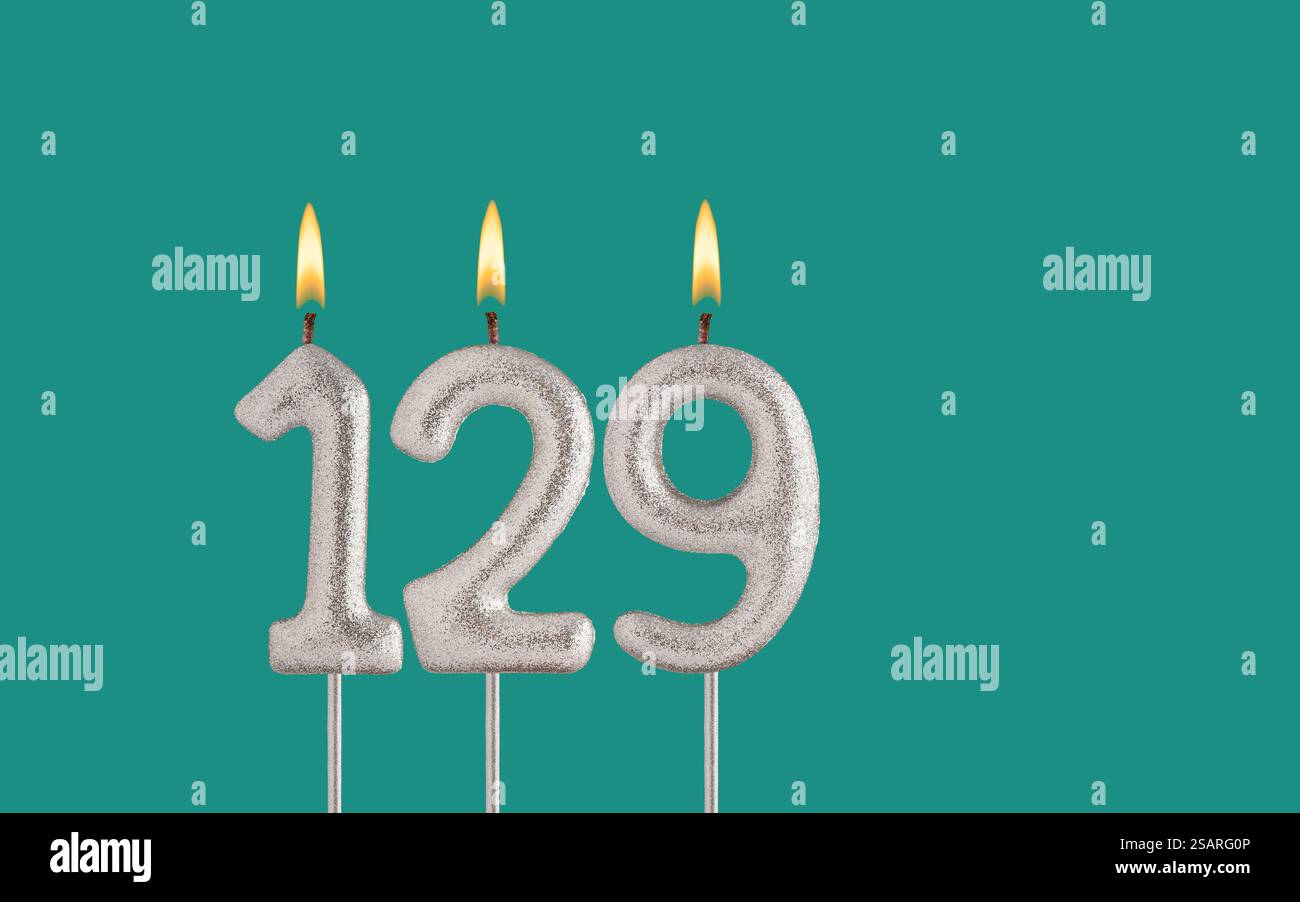 Birthday candle number 129 - Card on a green background Stock Photo - Alamy