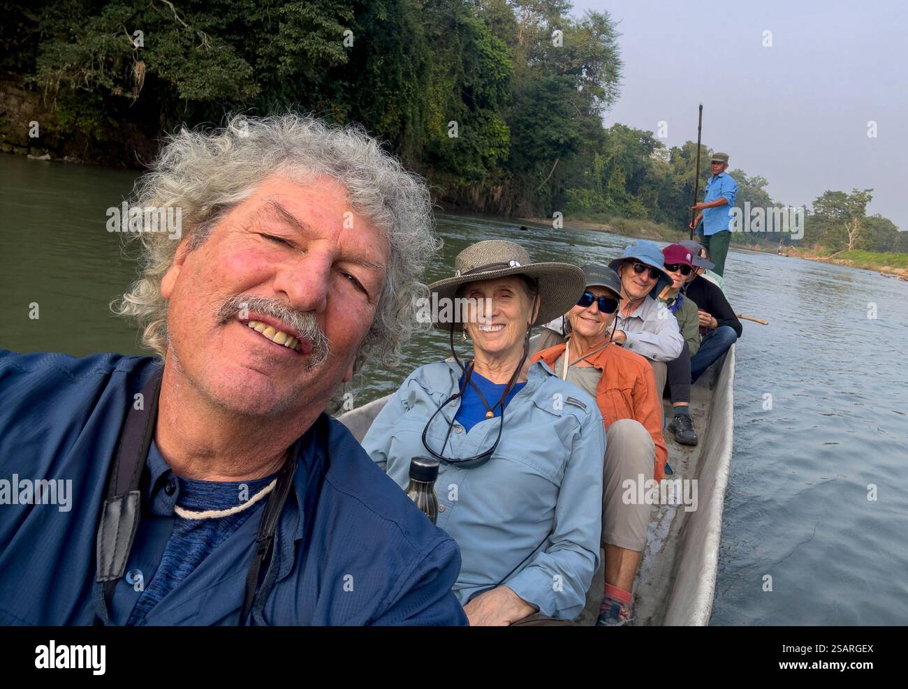 Tourists enjoy a boat ride on the Narayani River which defines the ...