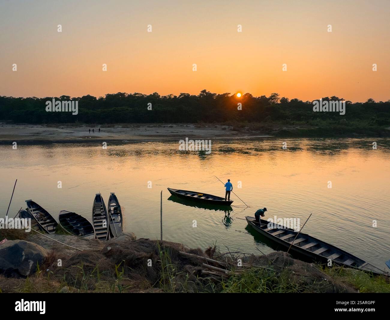 Sunset on the Narayani River which defines the boundary of the Chitwan ...