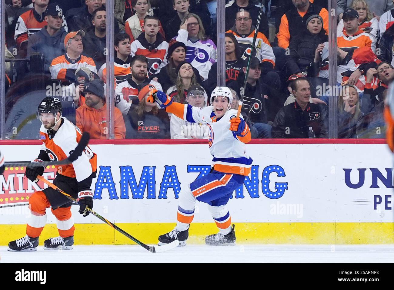 New York Islanders' Marc Gatcomb, right, celebrates past Philadelphia ...
