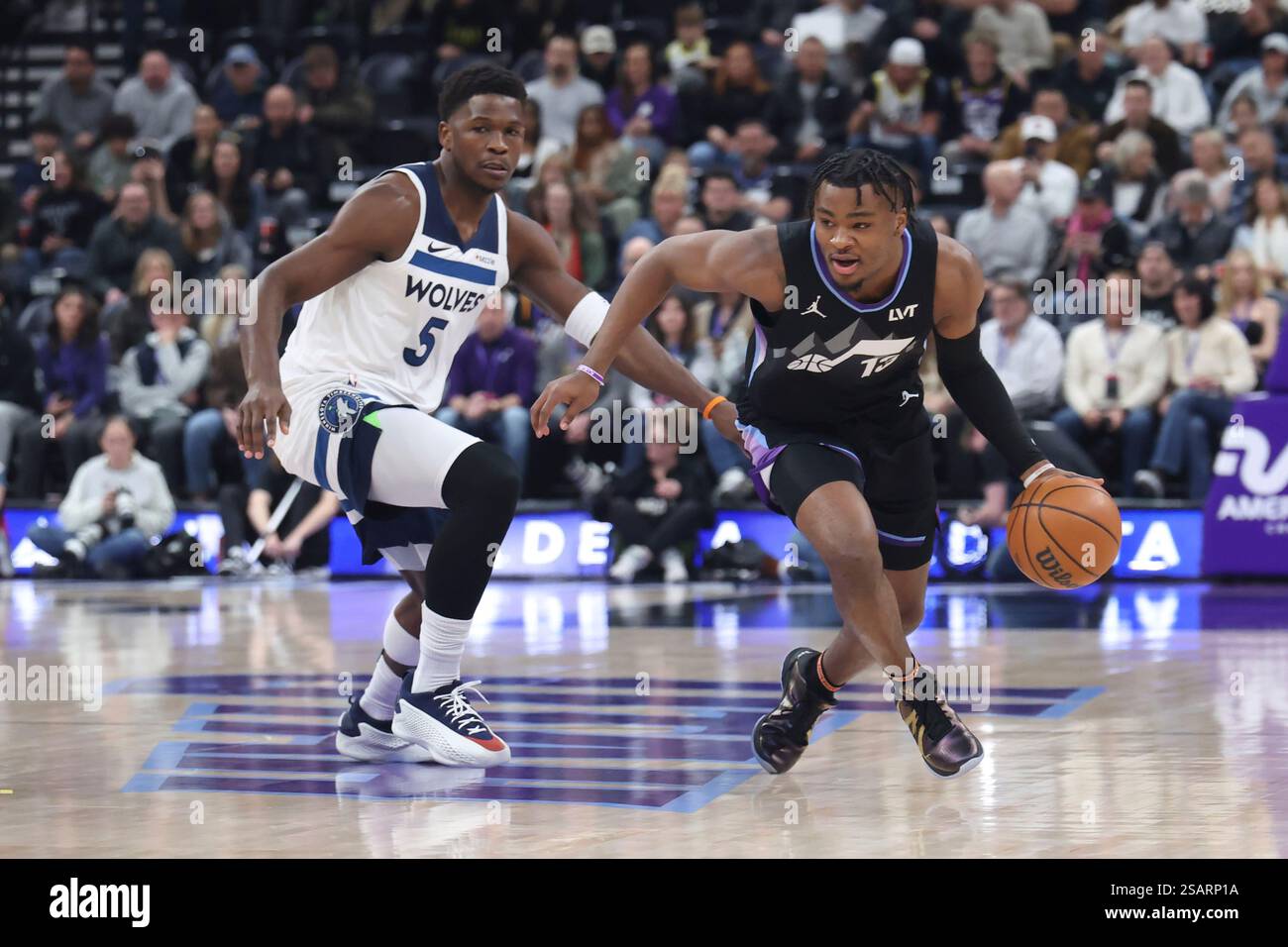 Utah Jazz guard Isaiah Collier, right, dribbles the ball against ...