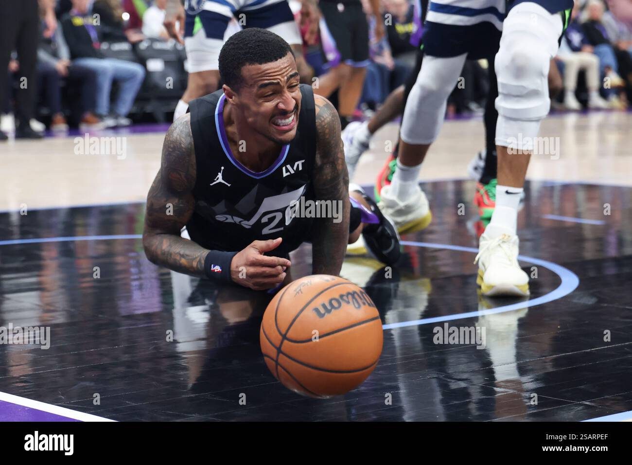 Utah Jazz forward John Collins goes to the floor against the Minnesota ...