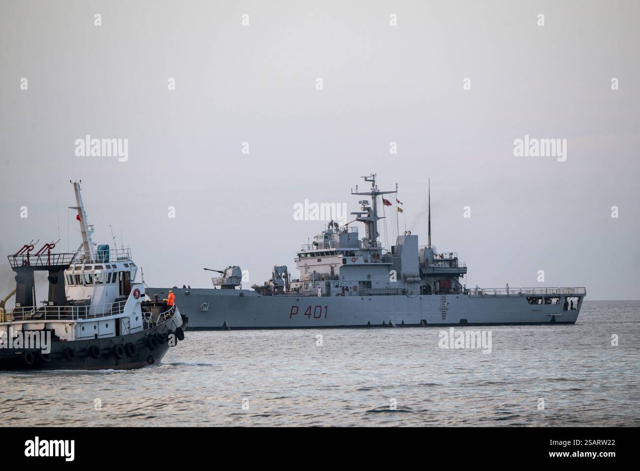 A tug seen in front of the Cassiopea navy ship. 49 migrants, from ...
