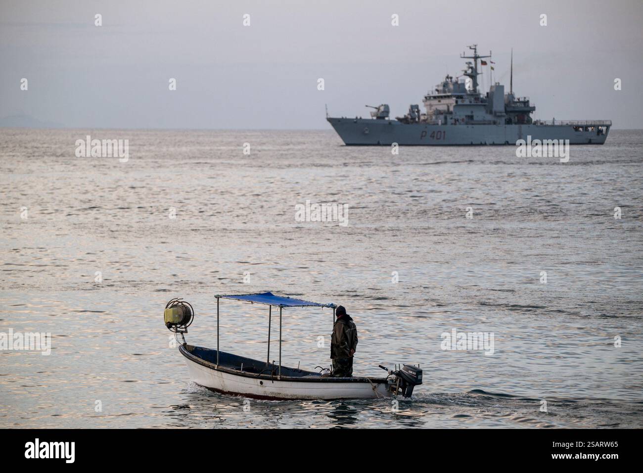 A fisherman seen in front navy ship Cassiopea. 49 migrants, from ...