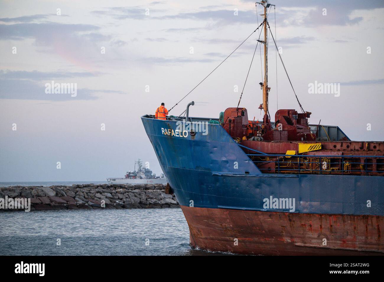A fisherman seen in front on the navy ship Cassiopea arriving in the ...