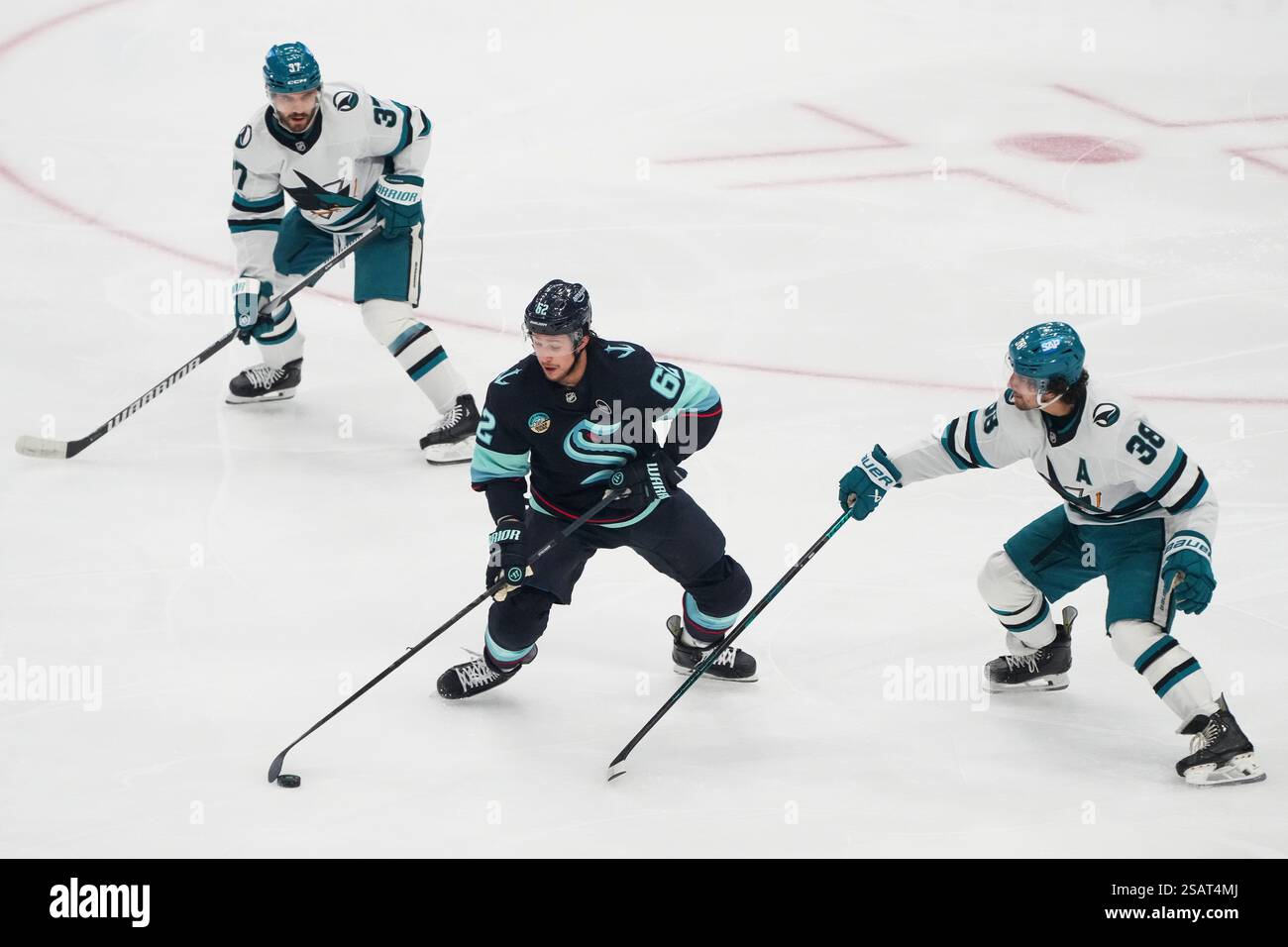 Seattle Kraken defenseman Brandon Montour, center, moves the puck ...