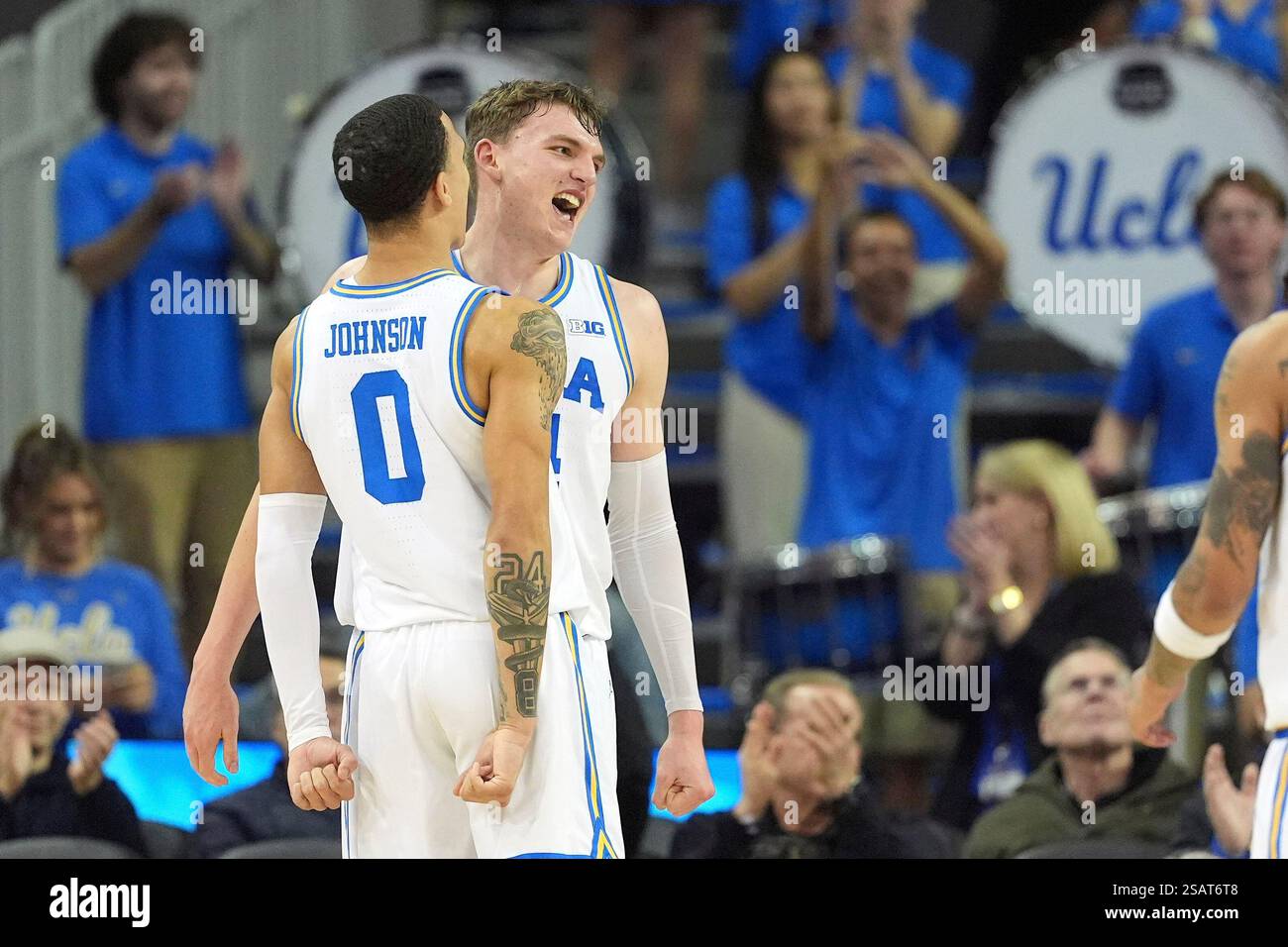 UCLA forward Tyler Bilodeau, right, celebrates with guard Ra'Heim Moss ...