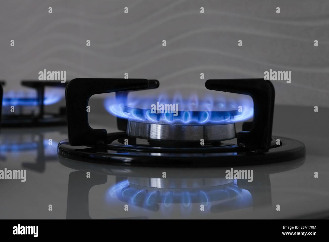 Modern gas cooktop with burning blue flames in kitchen Stock Photo - Alamy