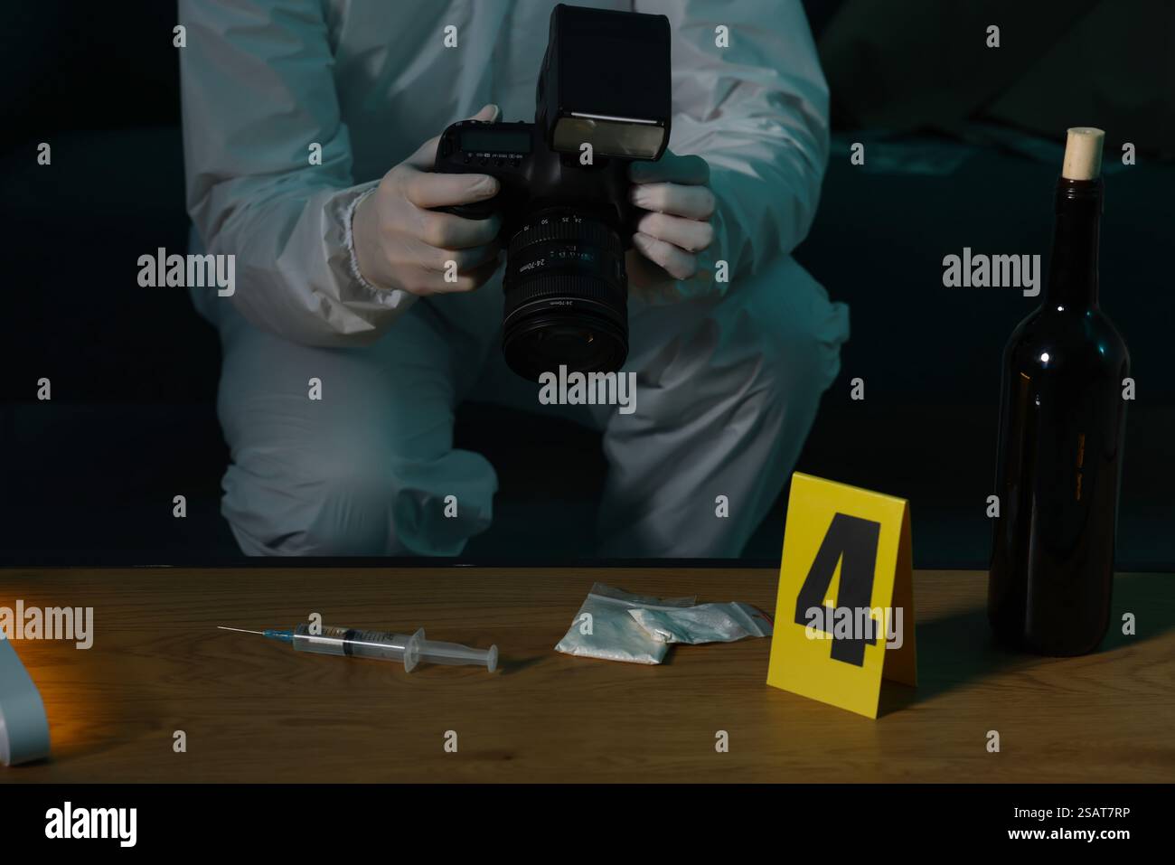 Forensic expert with camera taking photo of evidences at crime scene ...