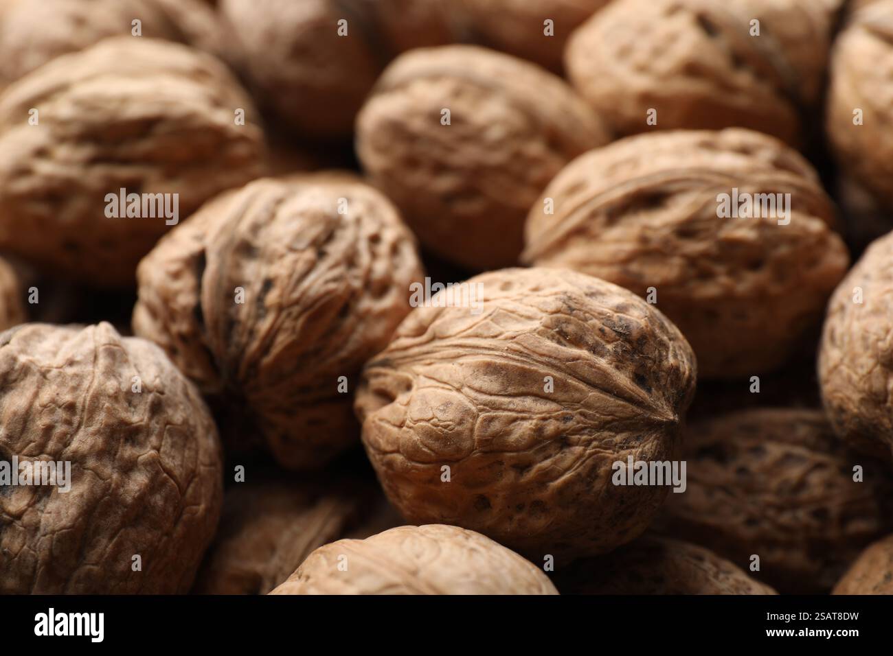 Fresh walnuts in shells as background, closeup Stock Photo - Alamy