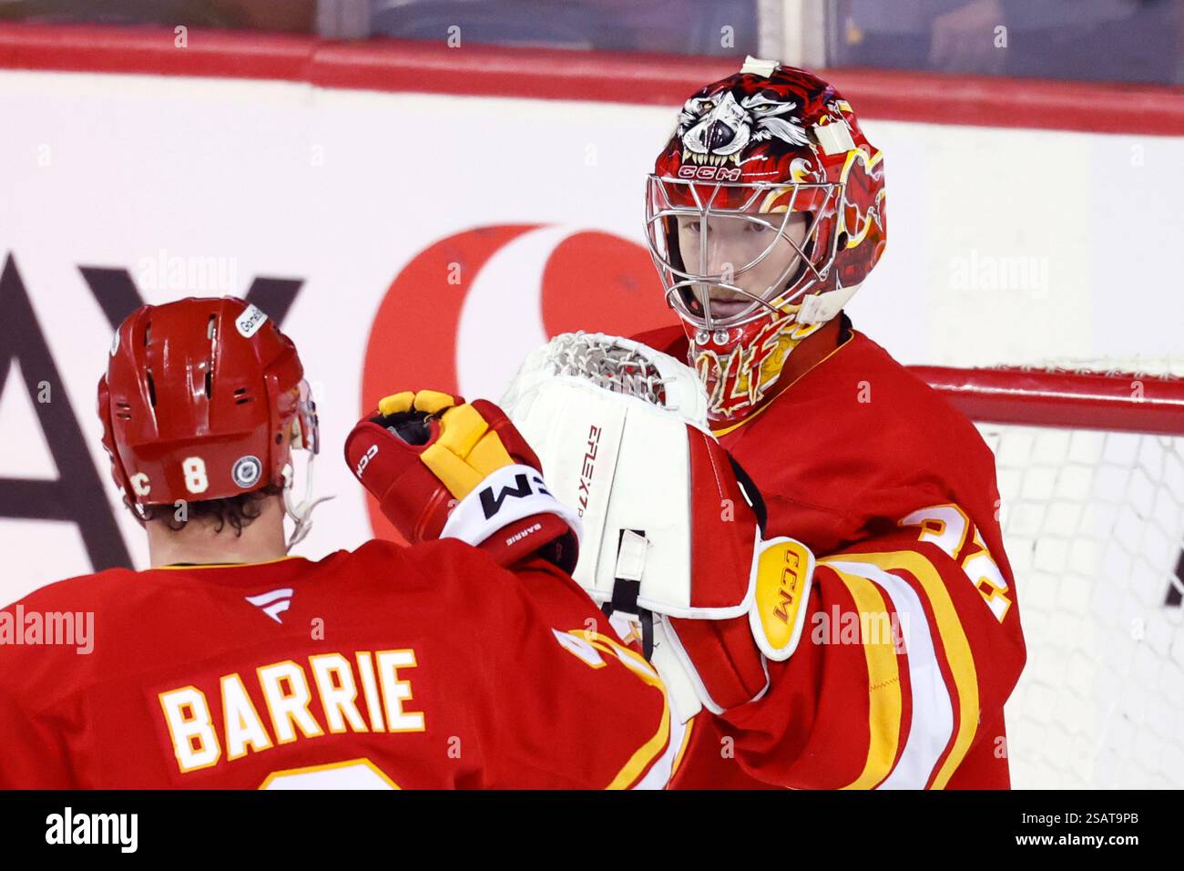 Calgary Flames goalie Dustin Wolf (32) celebrates with Tyson Barrie (8 ...