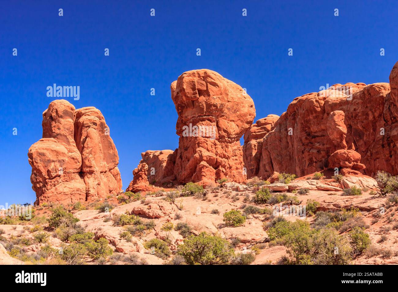 A rocky landscape with three large rocks, each with a distinct shape ...