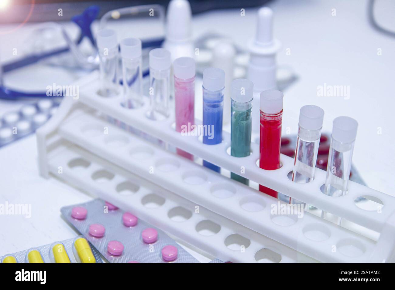 Lab setup with colorful test tubes and pills in blister packs Stock ...