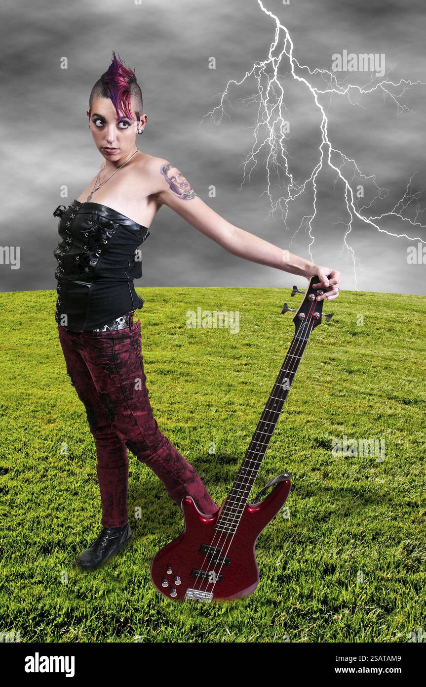 Beautiful woman punk rocker with an electric bass guitar Stock Photo ...