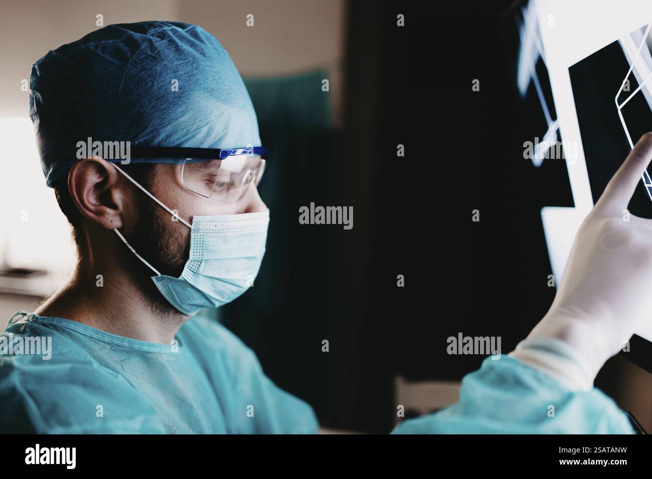 Doctor focused while analyzing x-ray with finger point Stock Photo - Alamy