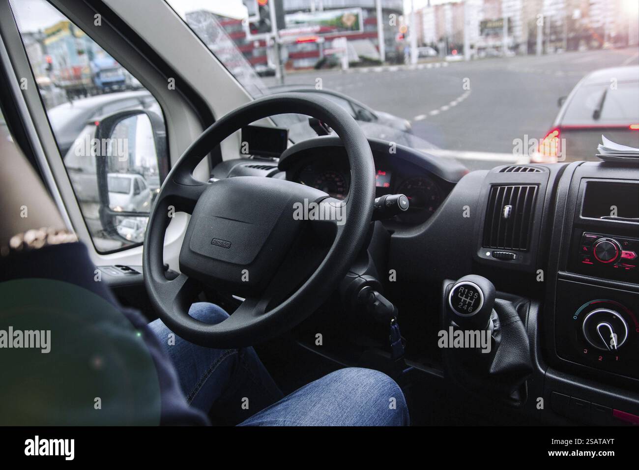 Inside a vehicle with a view of traffic and buildings through the ...