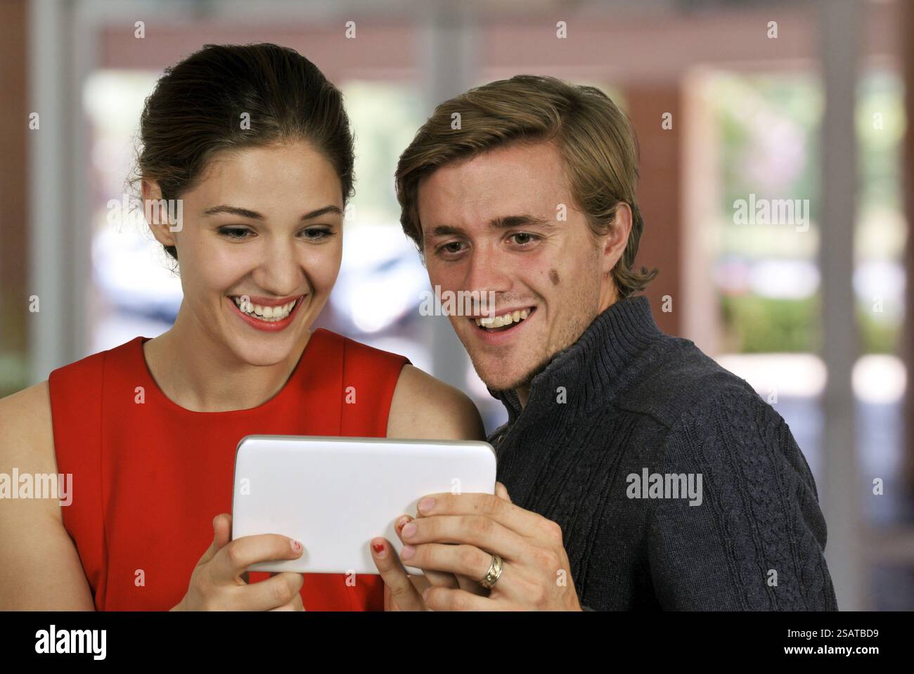 Beautiful technologically savvy woman using a tablet Stock Photo - Alamy