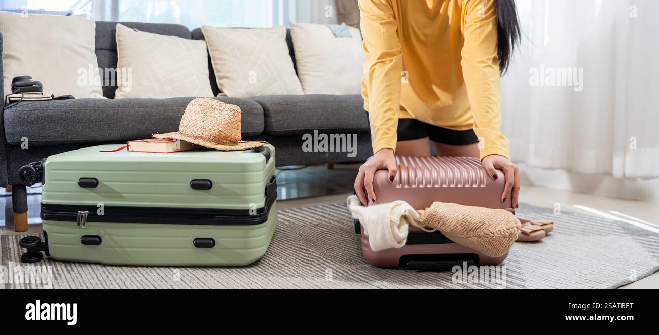 Young girl sitting on top of overflowing suitcase. Packing for vacation ...