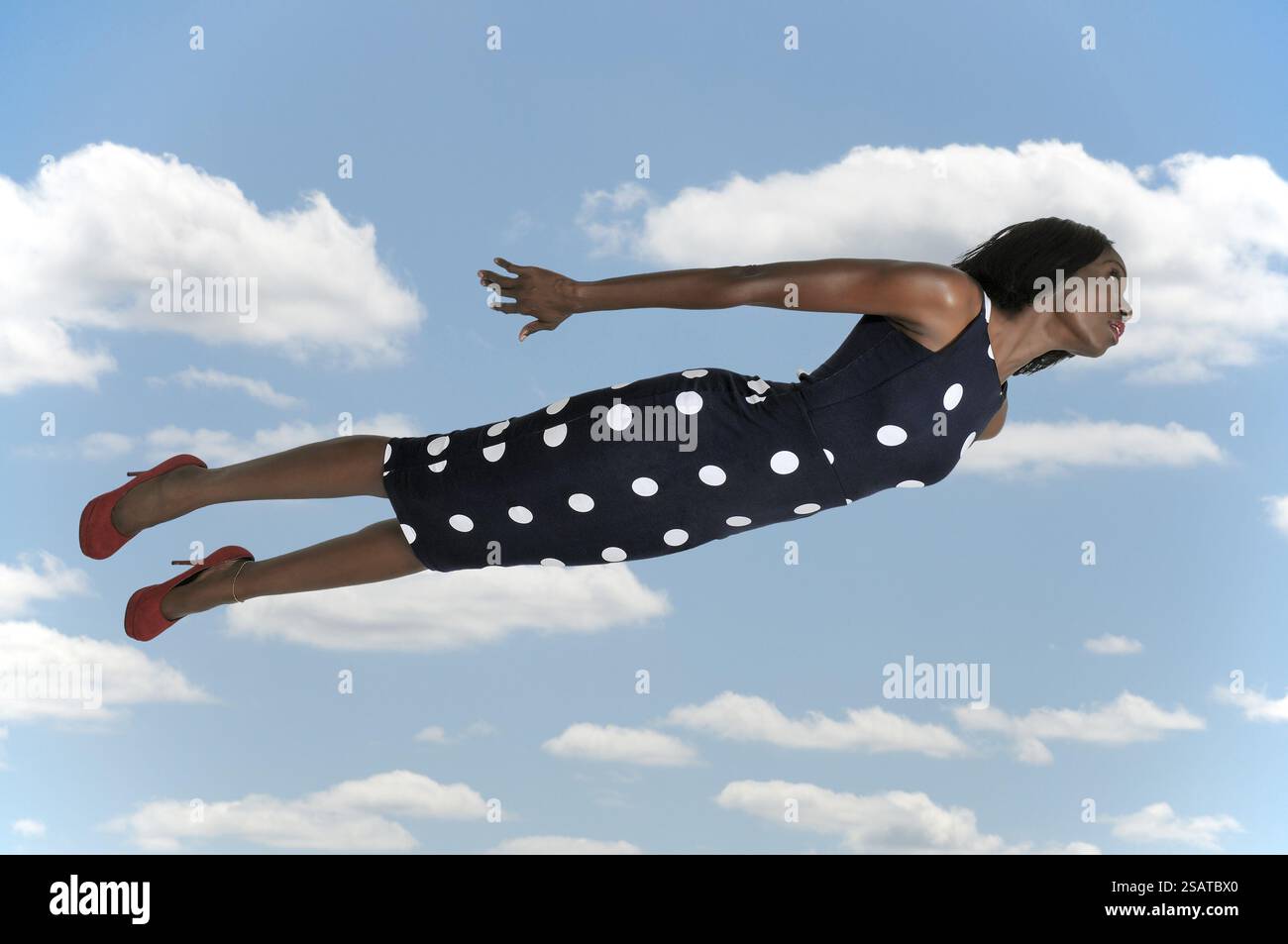 Beautiful young woman flying or falling through the air Stock Photo - Alamy