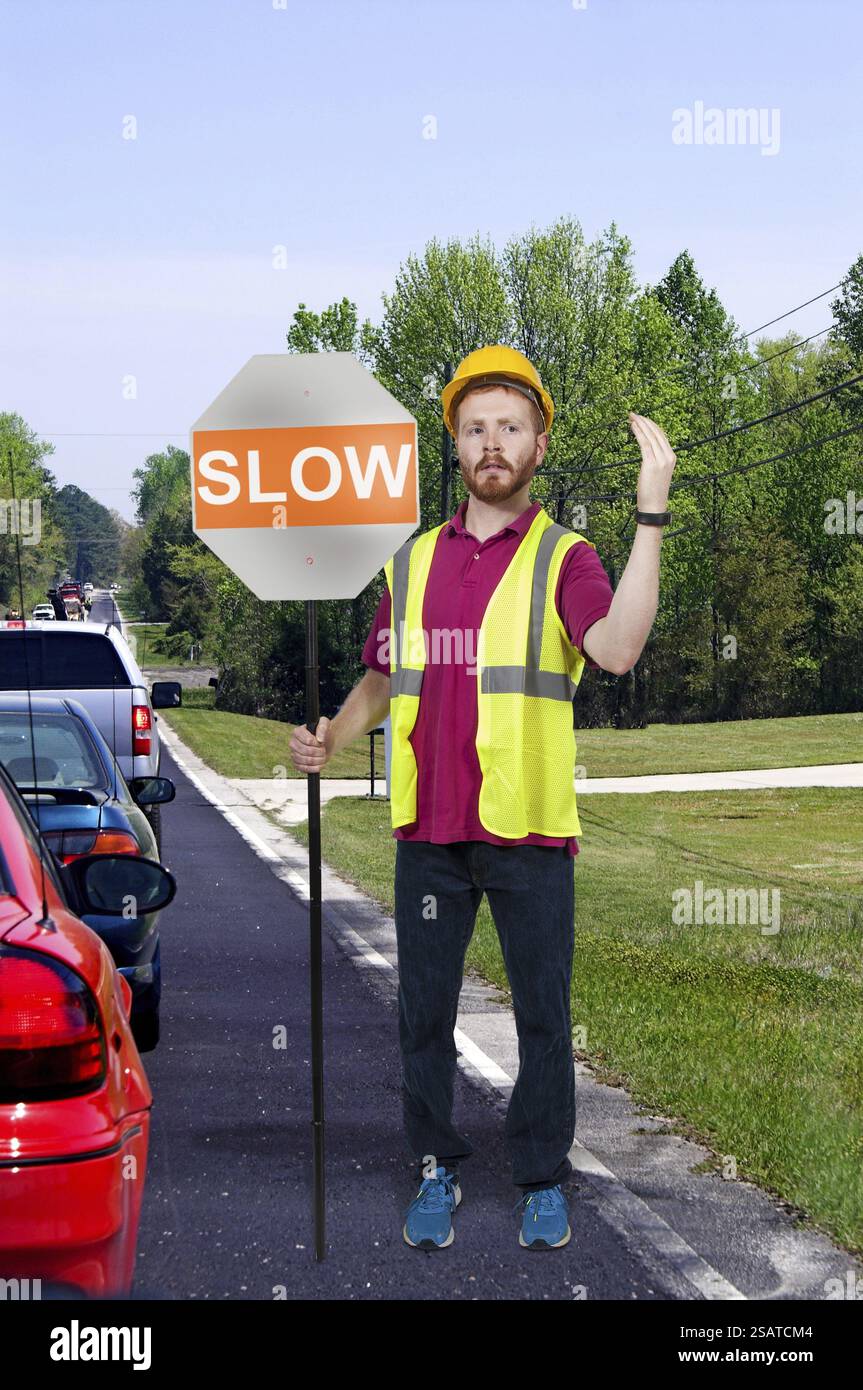 Man flagman holding a stop sign to halt traffic Stock Photo - Alamy