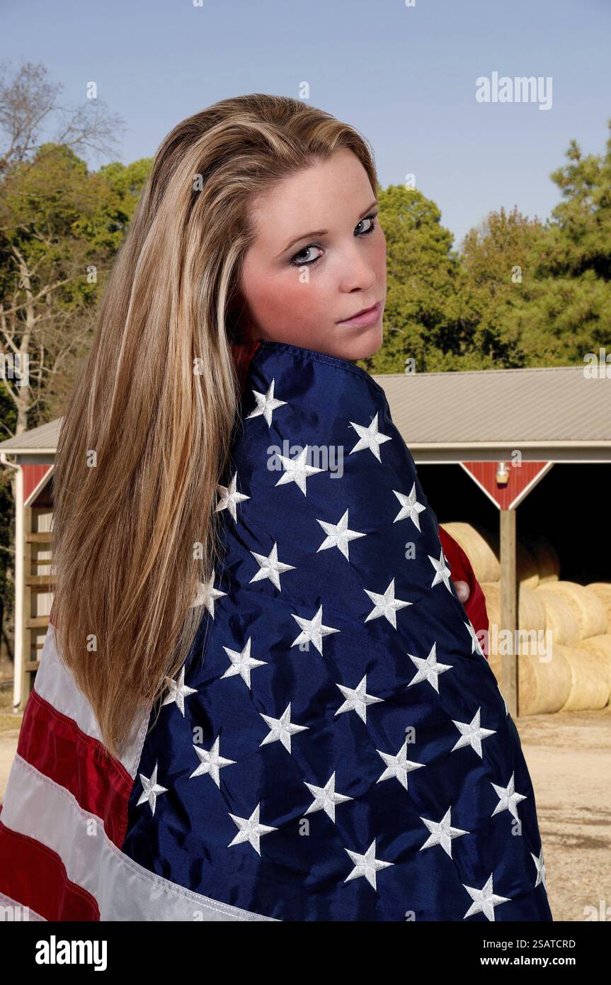 Beautiful young woman wrapped in a flag Stock Photo - Alamy