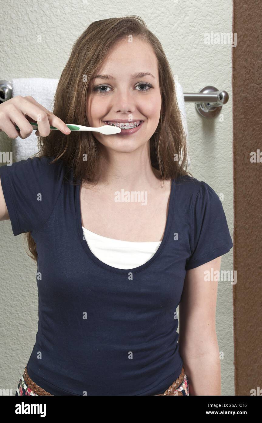 Beautiful teenage woman practicing good oral dental care by brushing her teeth Stock Photo - Alamy