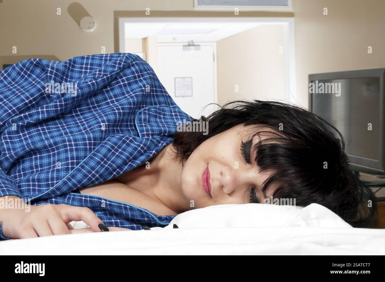 Beautiful young woman in bed at bedtime Stock Photo - Alamy