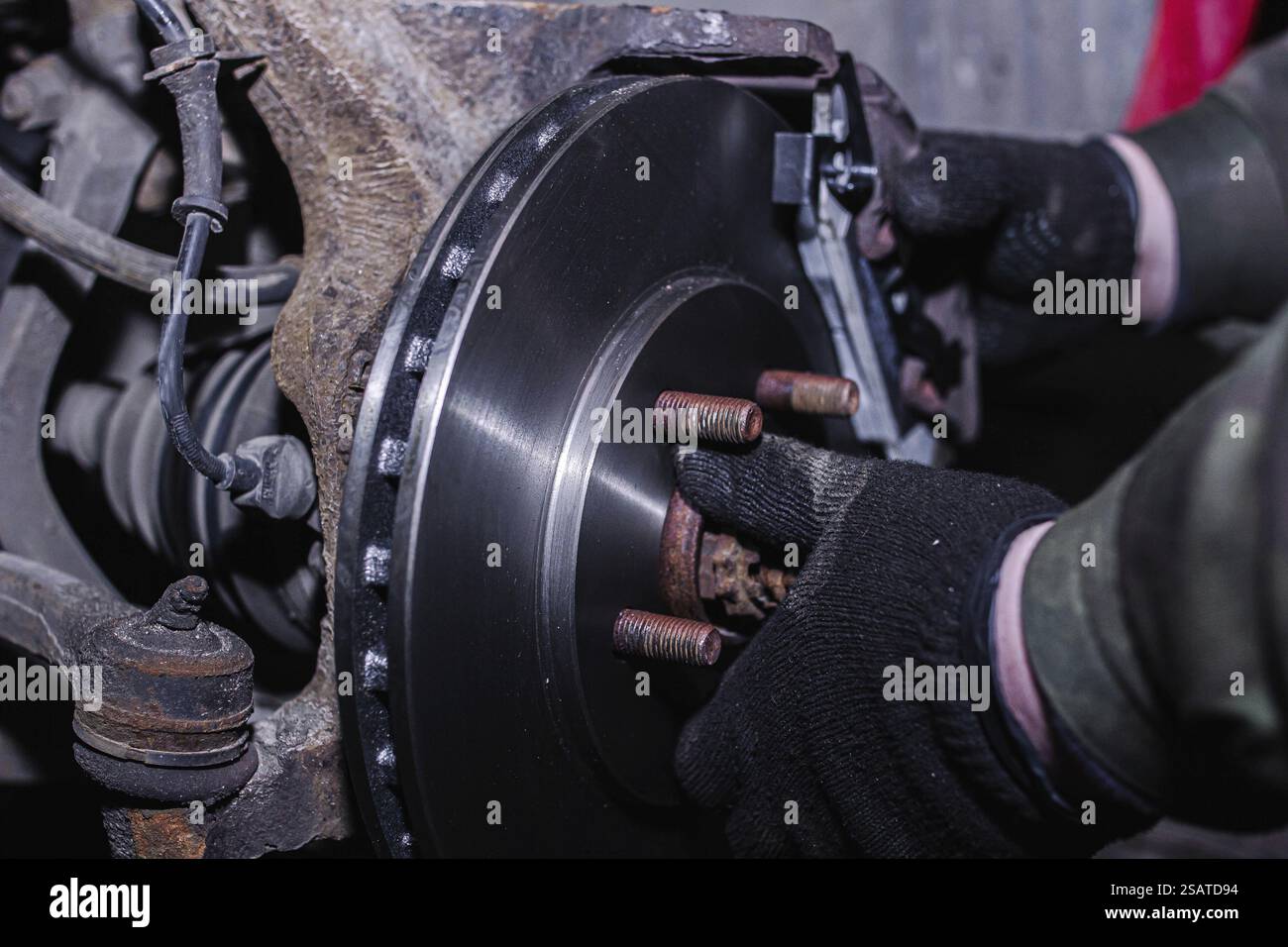 Installation of a brake disc by a mechanic with black gloves Stock ...