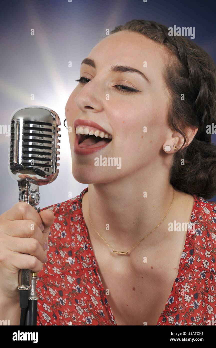 Beautiful woman singer performing with a vintage microphone Stock Photo ...