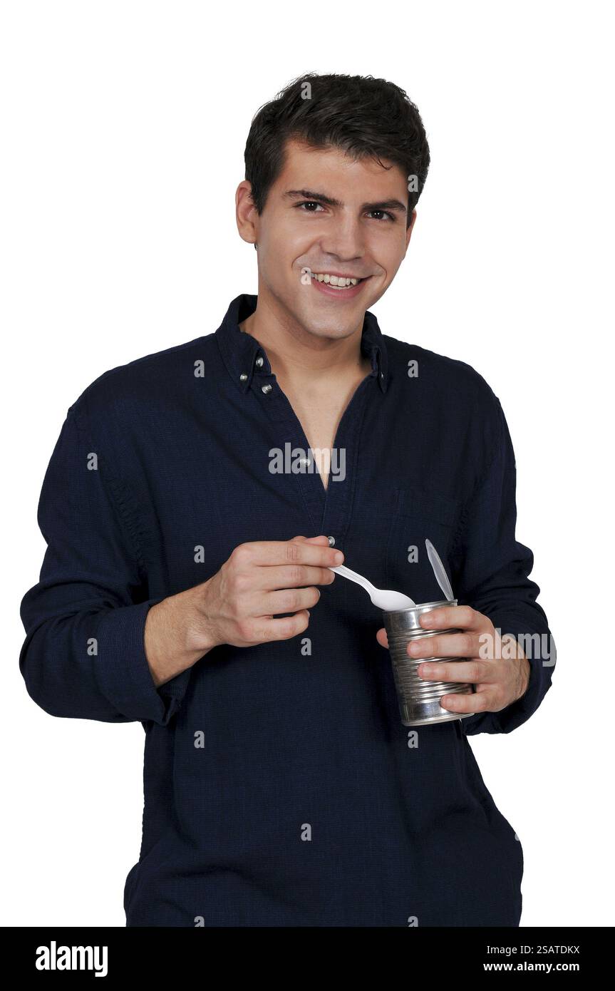 Man eating food out of a tin can Stock Photo - Alamy