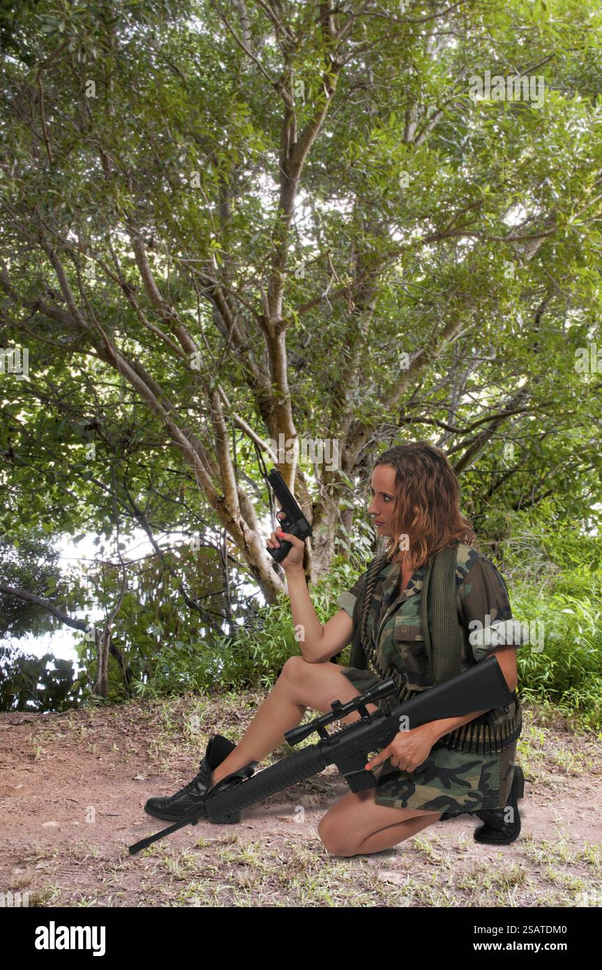 Beautiful young woman soldier with a M16 rifle and a pistol Stock Photo ...