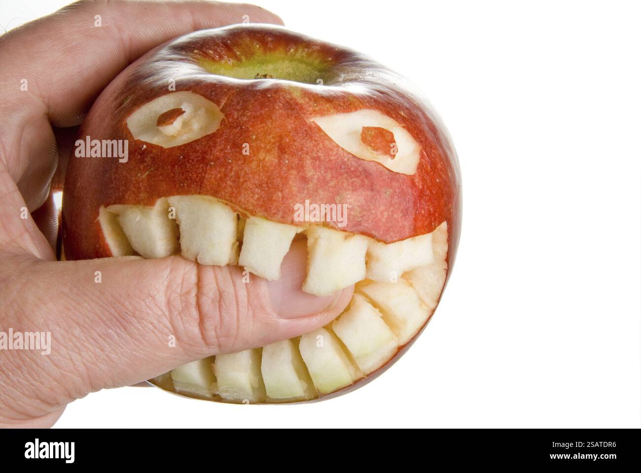 An apple biting the hand that eats it Stock Photo - Alamy