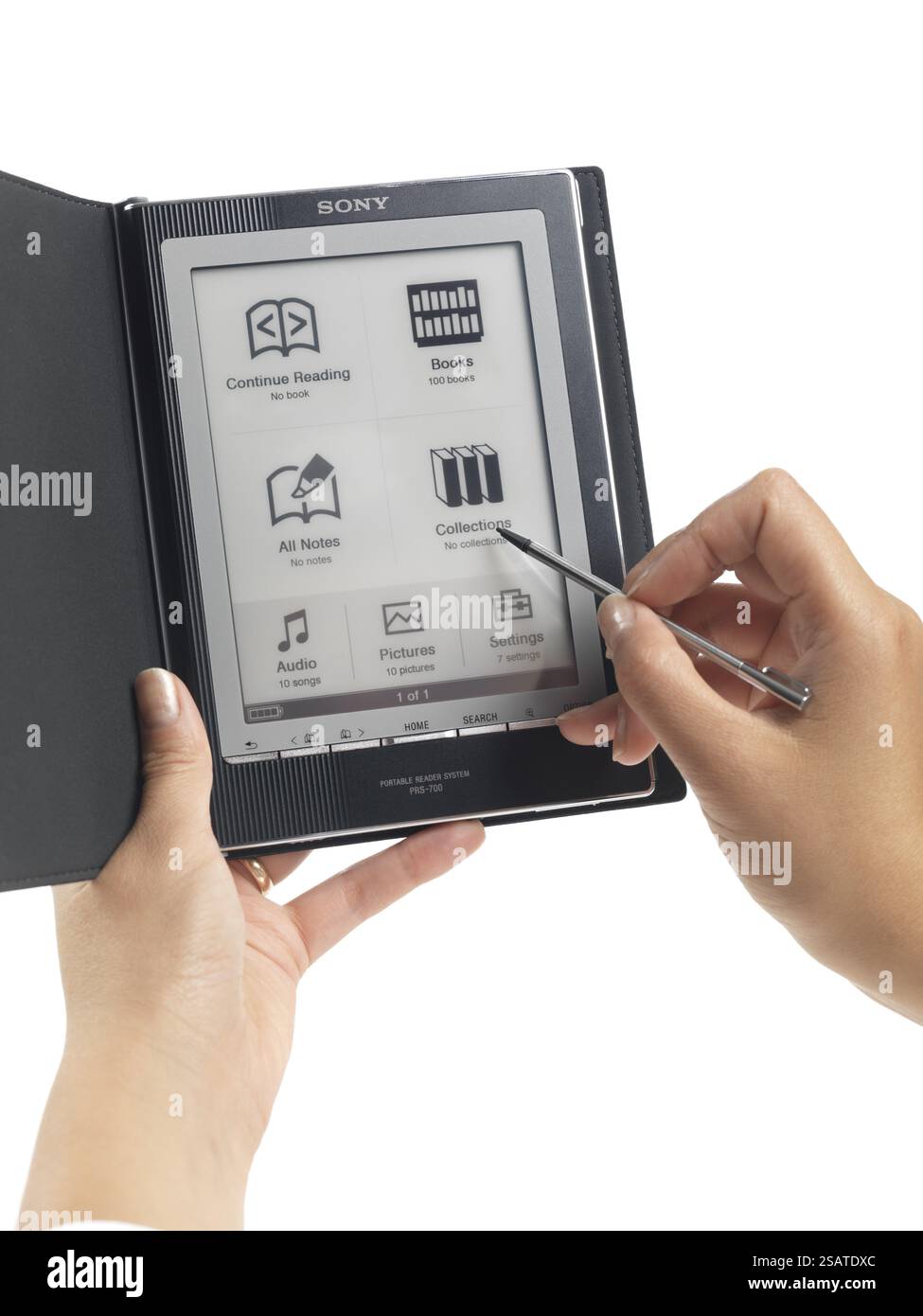 Woman using Sony Reader. PRS-700 Portable Reader System. Touch screen e ...