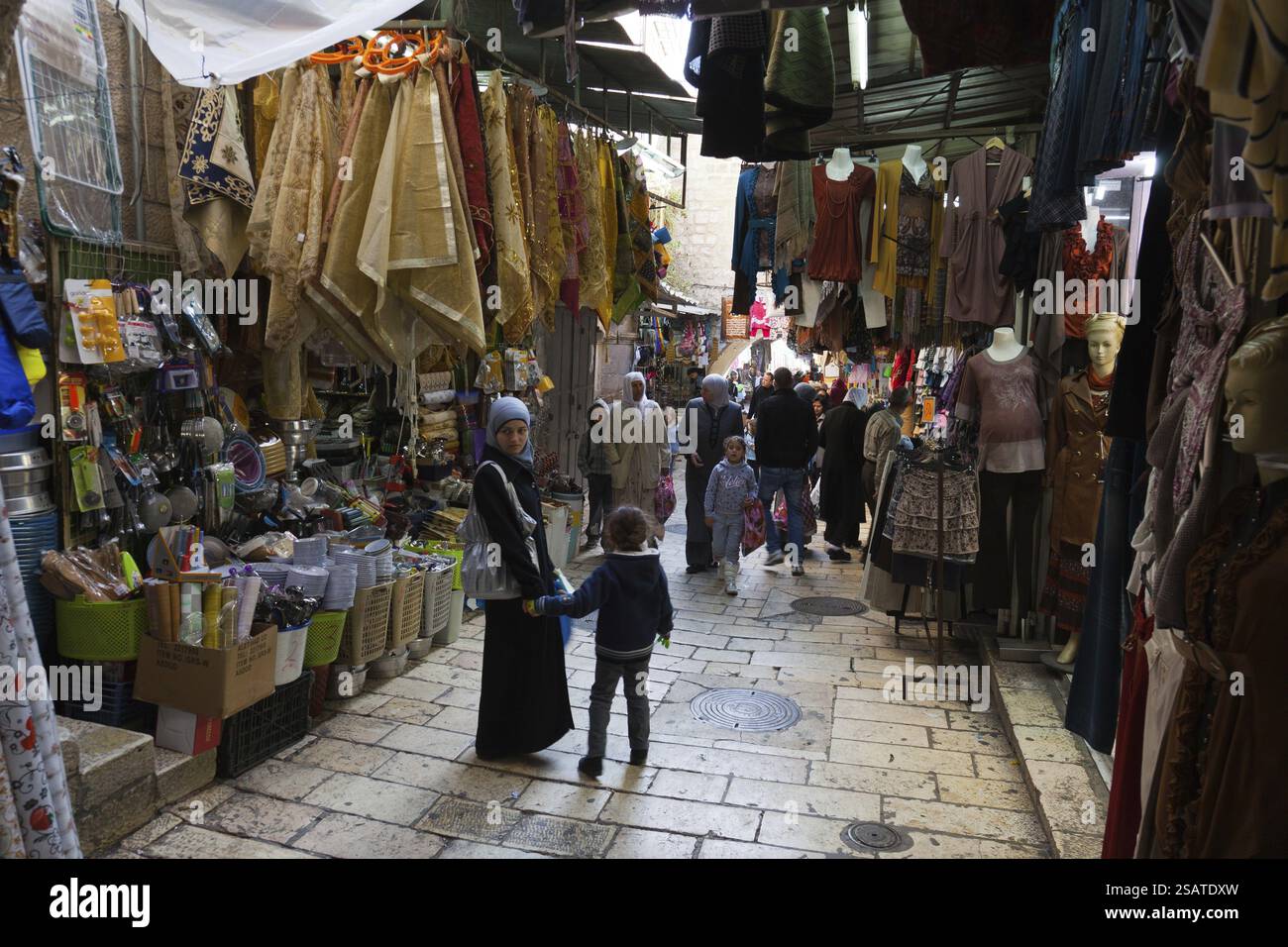 People walking along lines of shops and stalls in the ancient city of ...