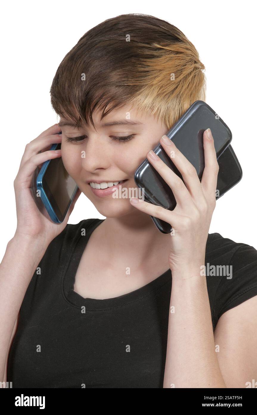 Beautiful woman talking and multitasking while juggling multiple cell ...