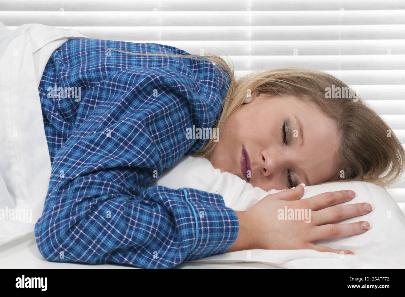 Beautiful young woman in bed at bedtime Stock Photo - Alamy