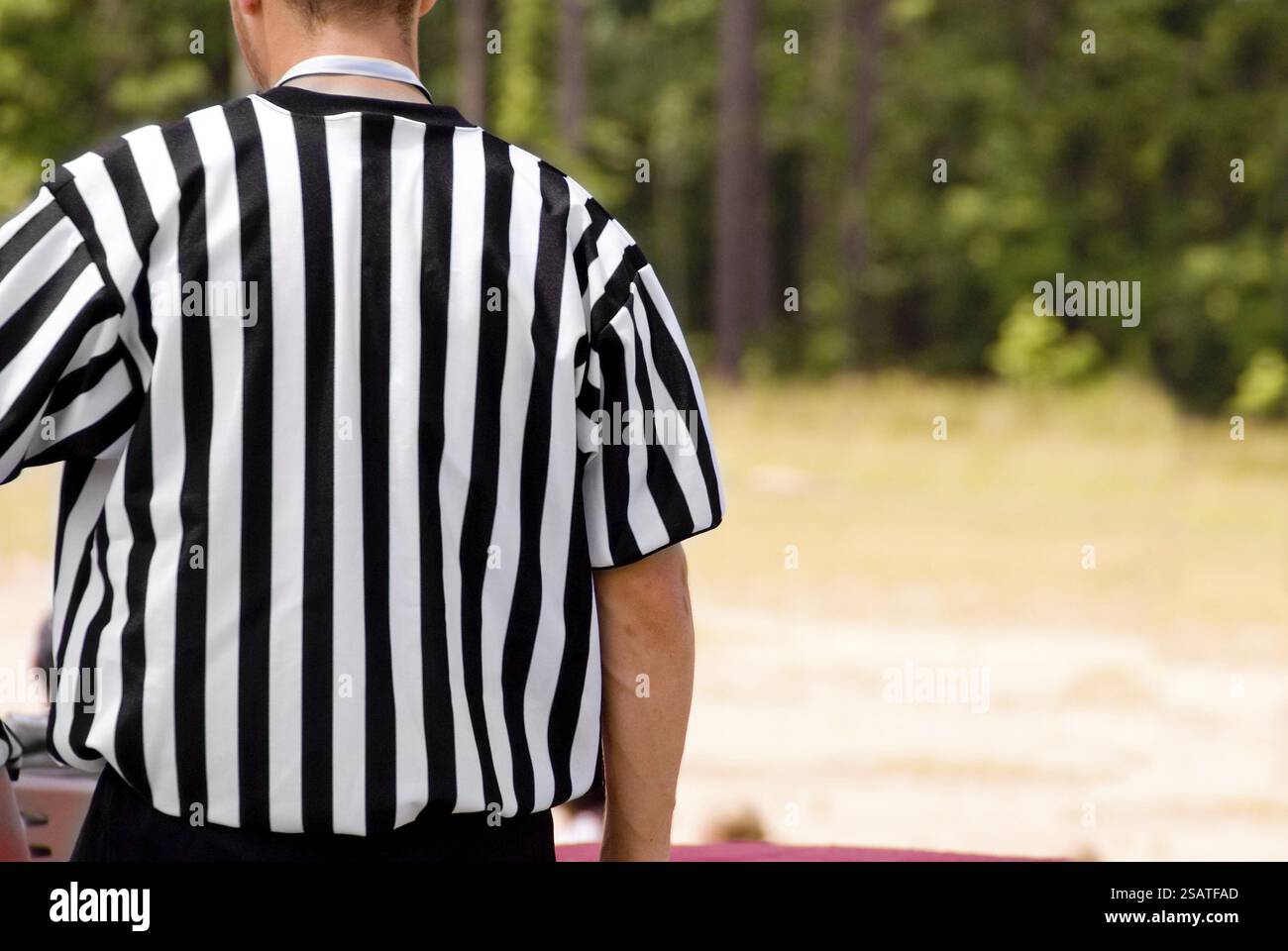 A sports referee wearing a traditional officials shirt Stock Photo - Alamy