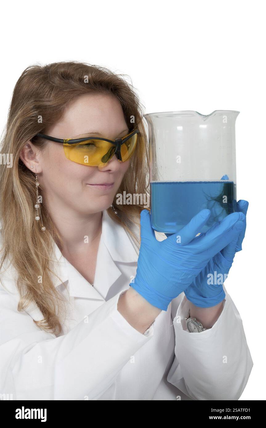 Beautiful woman scientist investigating a glass beaker Stock Photo - Alamy