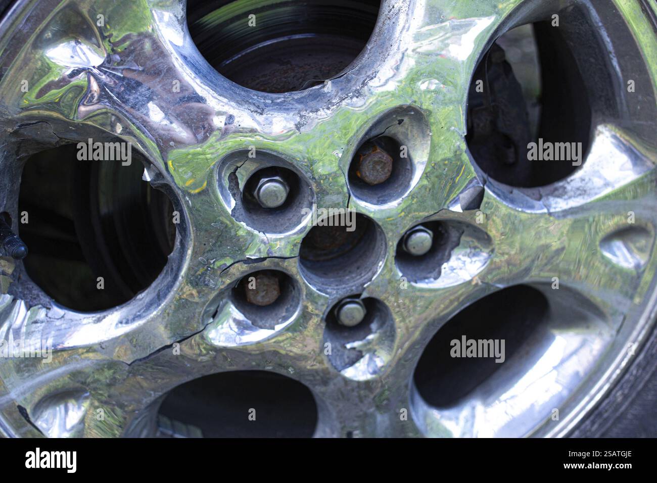 Cracked chrome wheel rim showing rust detail around bolt area Stock ...