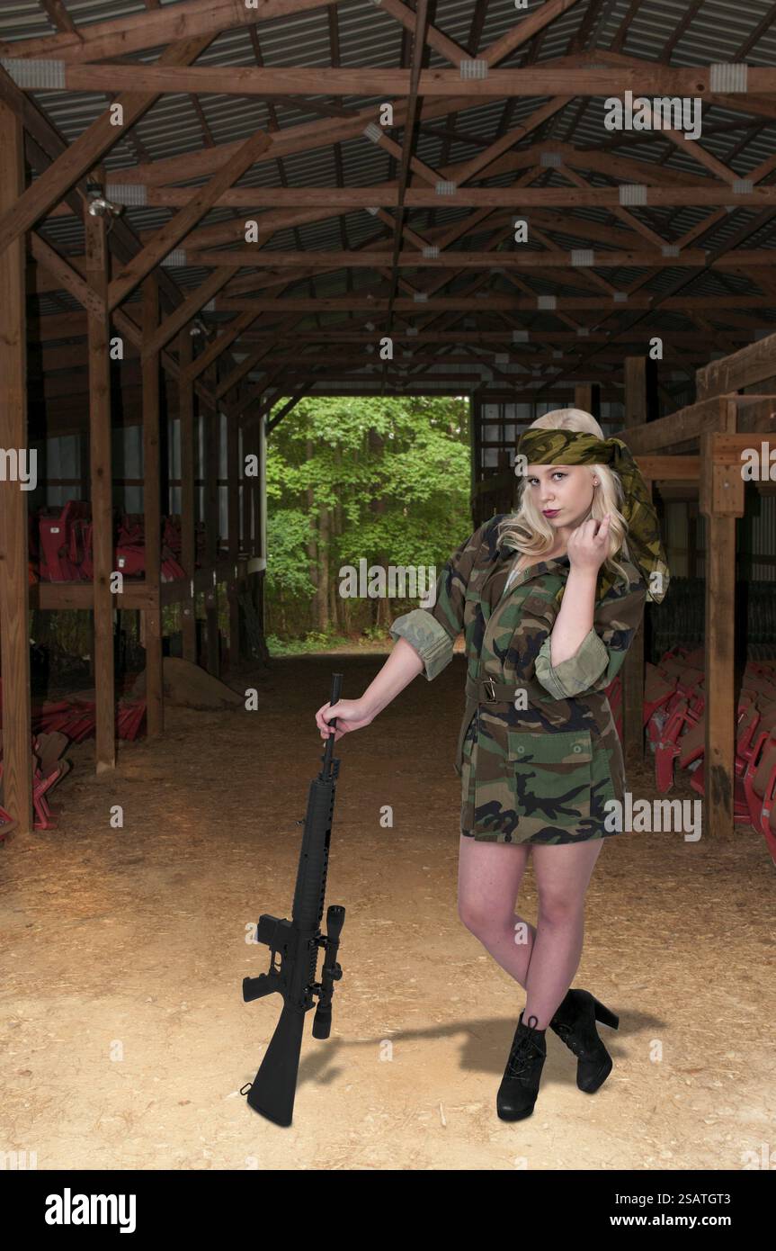Beautiful young flirting woman soldier with a M16 rifle Stock Photo - Alamy