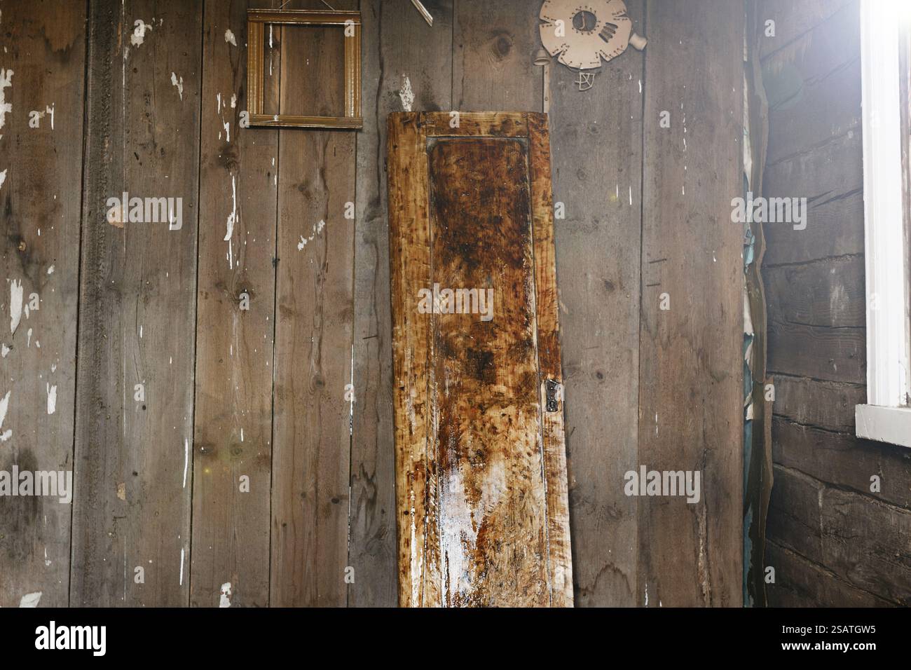 Rustic wooden door against an aged wooden wall indoors Stock Photo - Alamy