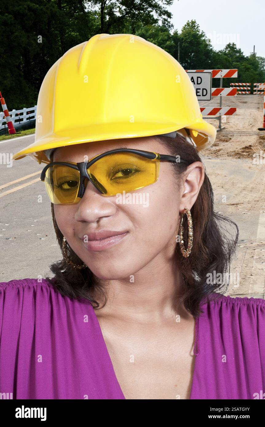 A black African American Woman Construction Worker wearing a hard hat and safety glasses Stock ...