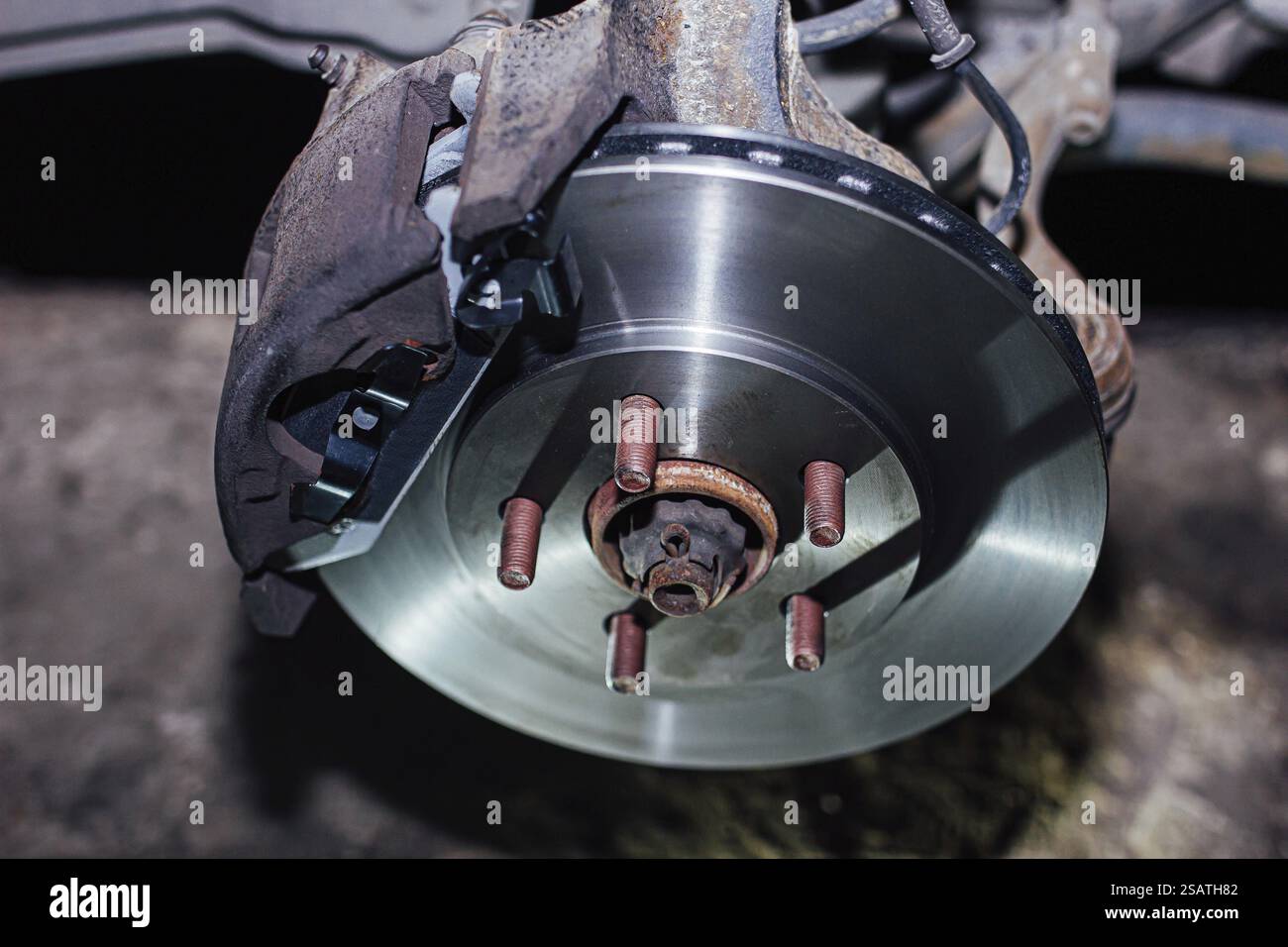 Exposed car brake rotor and caliper showing wear and mechanical detail ...