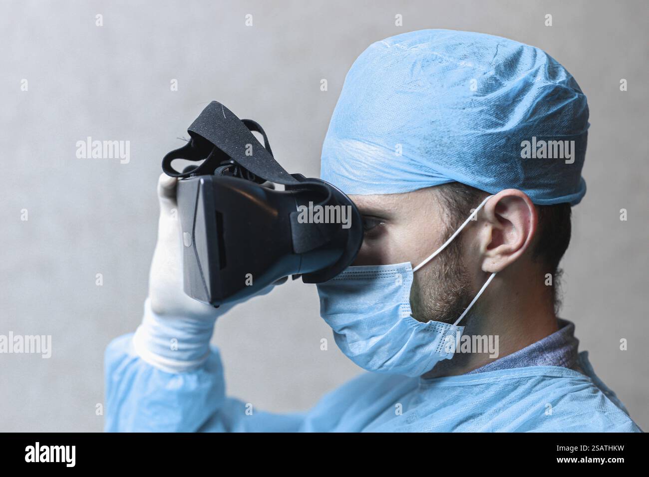 Medical professional using virtual reality goggles while wearing ...
