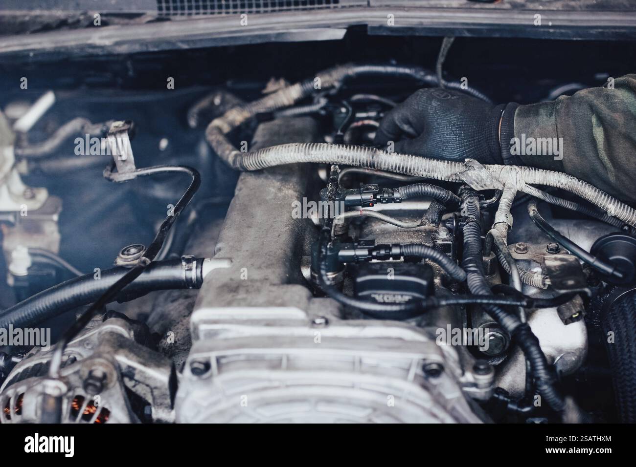Focused view of a mechanic's hands working on detailed engine ...
