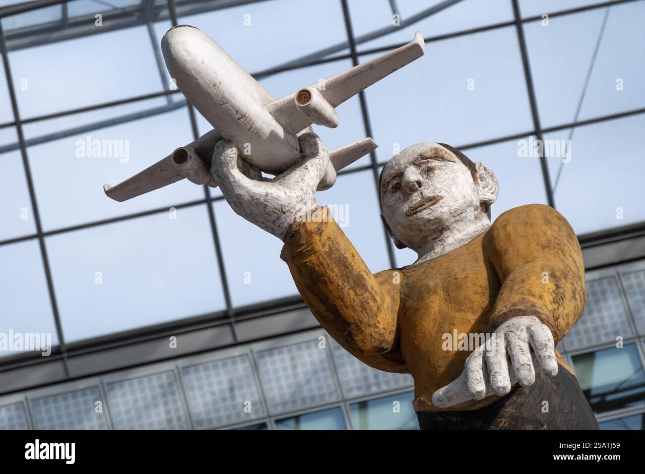 Sculpture, wooden figure with aeroplane at Munich Airport, Terminal 2 ...