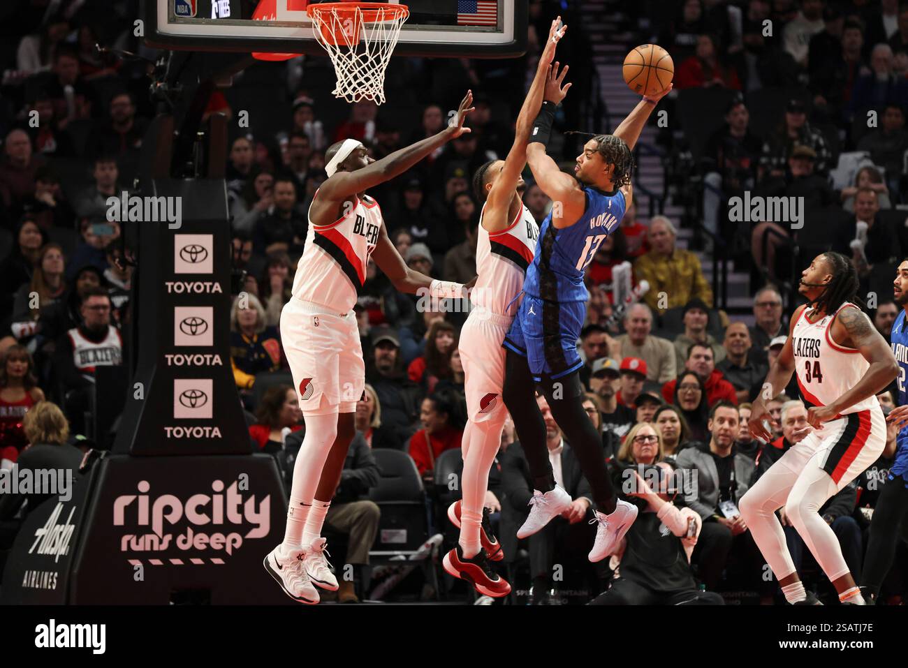 Orlando Magic guard Jett Howard, right, drives to the basket as Portland Trail Blazers center ...