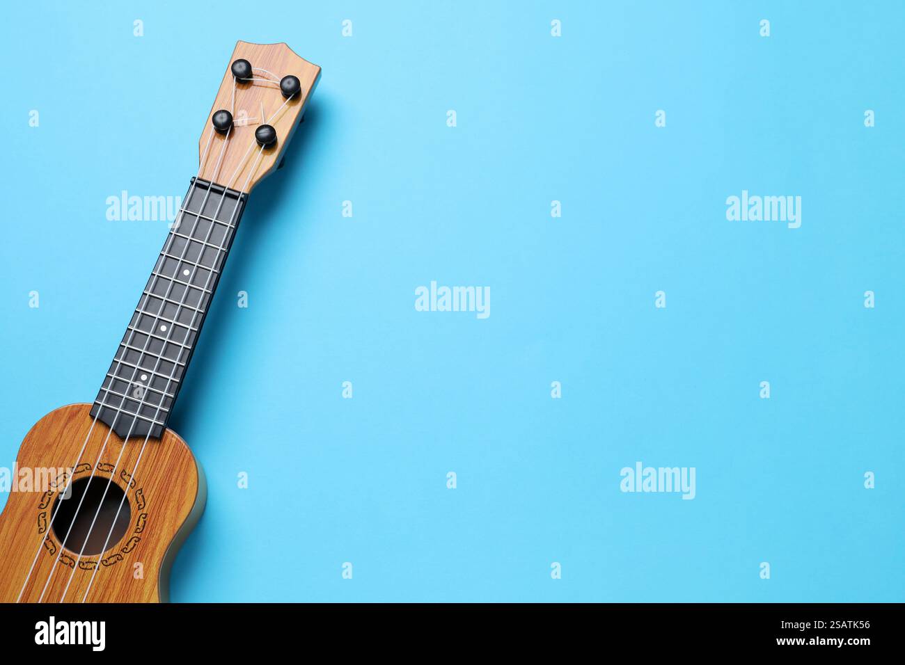 One ukulele on light blue background, top view. Space for text Stock ...
