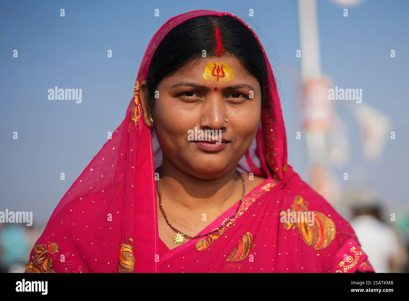 A Hindu devotee wears a sacred mark on her forehead at the confluence ...